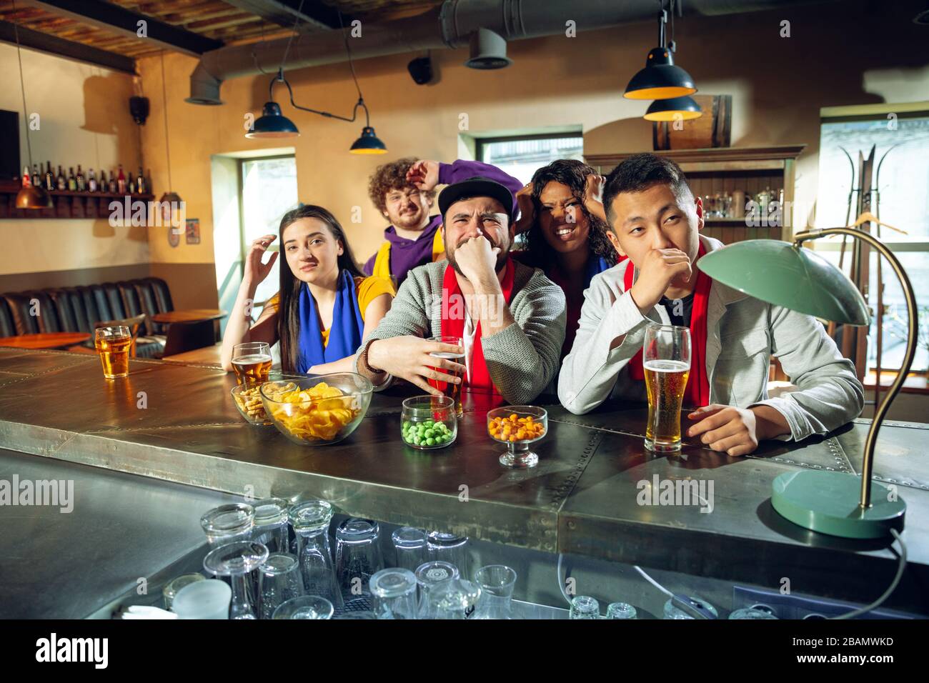 Sport fans cheering at bar, pub and drinking beer while championship ...