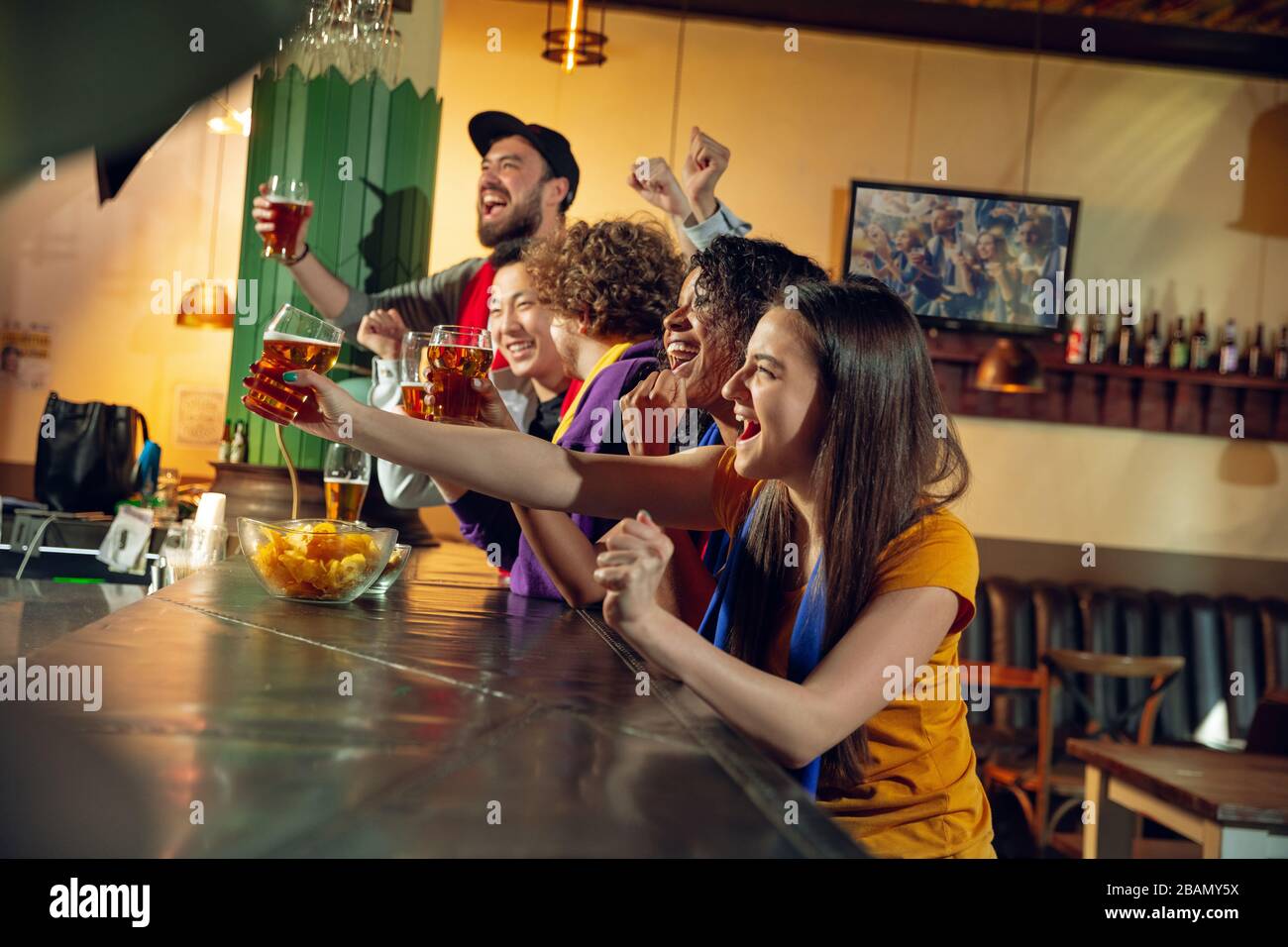 Sport fans cheering at bar, pub and drinking beer while championship ...