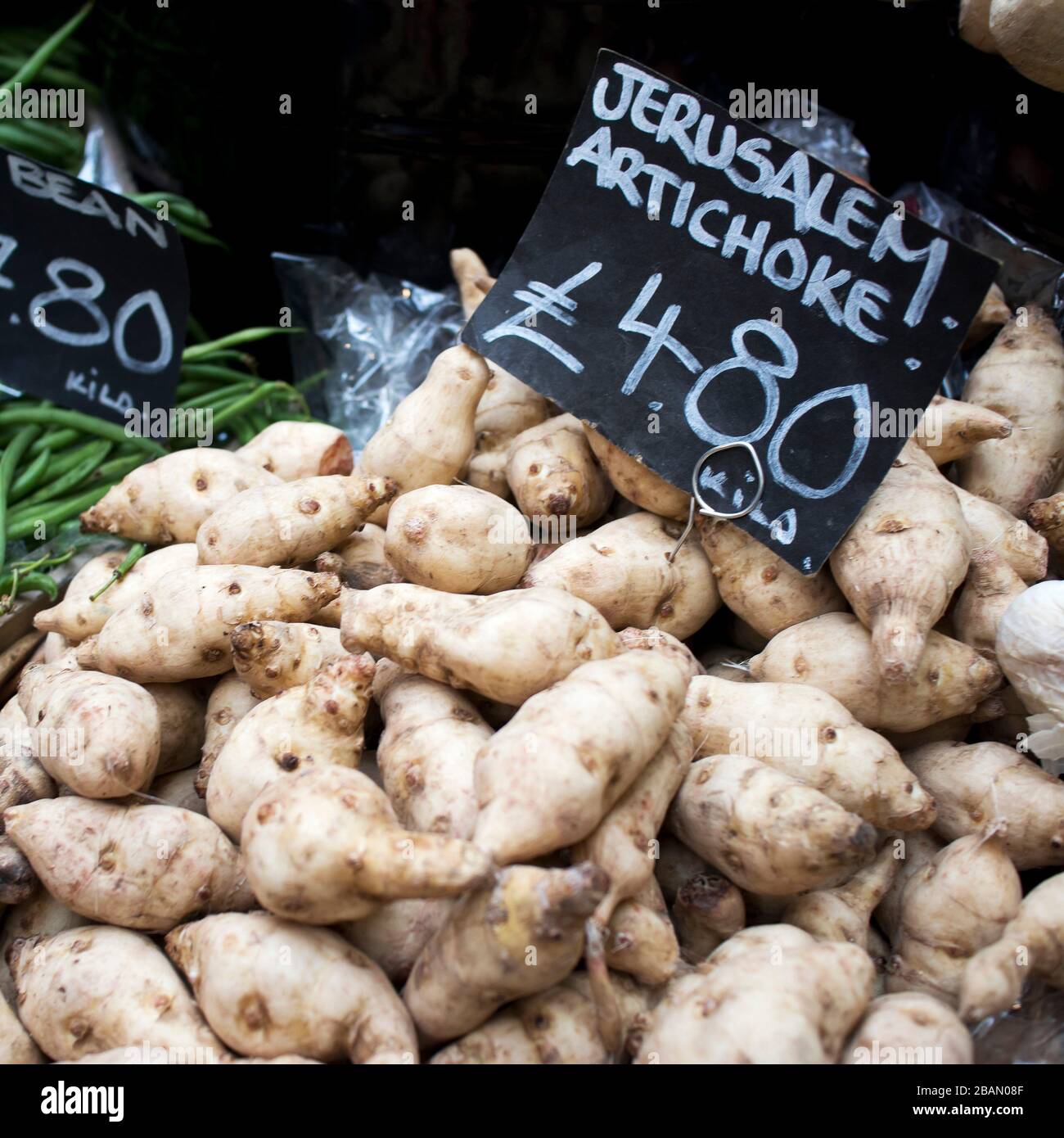 Square frame format. Jerusalem artichokes and fine bean for sale at a ...