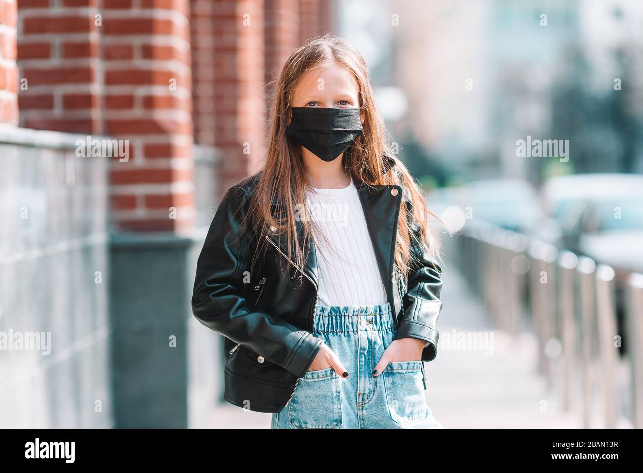 Girl wearing a mask on a background of a modern building Stock Photo ...
