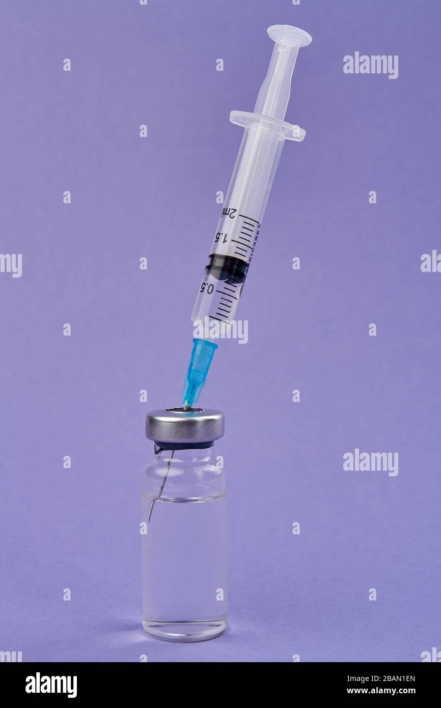 Syringe inserted into and medicine vial Stock Photo - Alamy