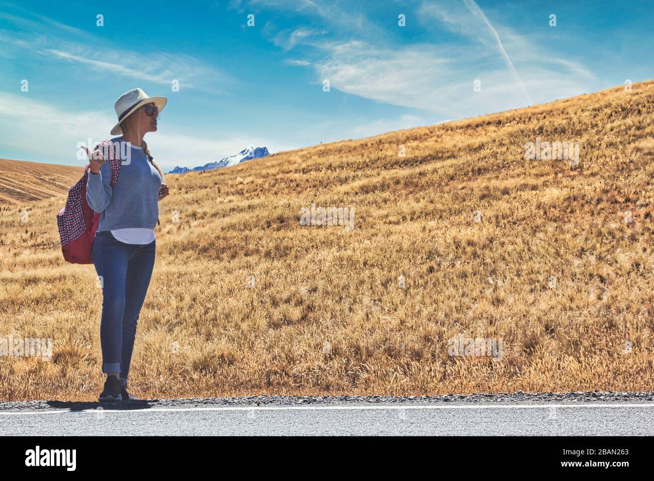 Beautiful woman hitchhiking on road in forest, hitchhiking with thumbs ...