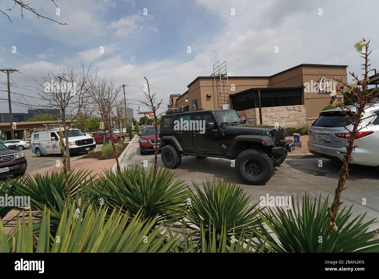 Long lines at Raisin' Cane's fast food drive through in Dallas during ...