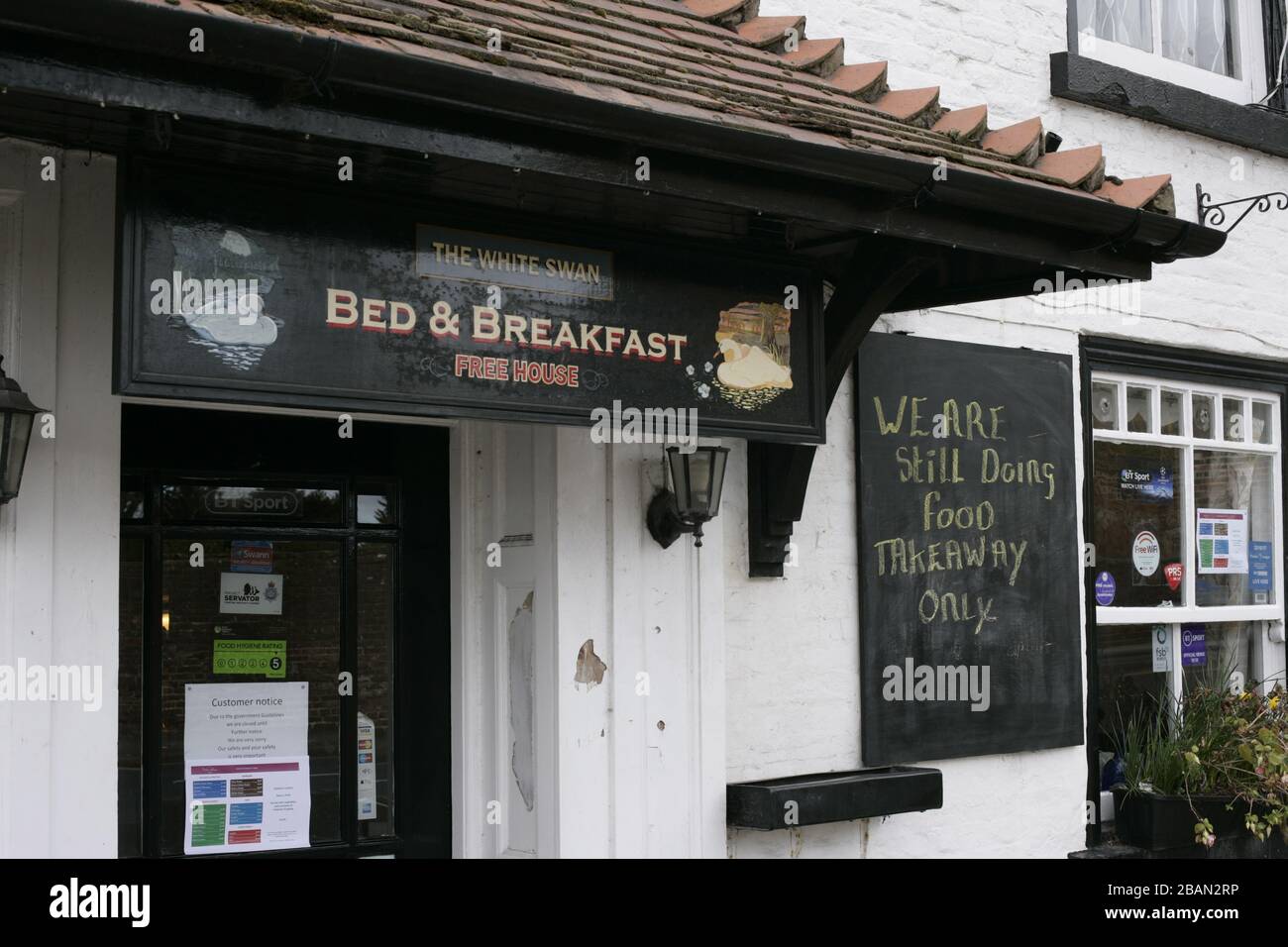 Customer notice of closure sign on public house door window during ...