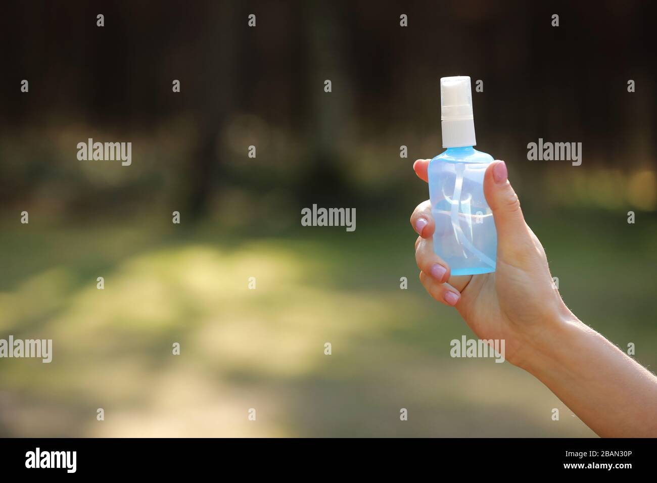 woman hand holding alcohol spray or anti bacteria spray outdoor to ...