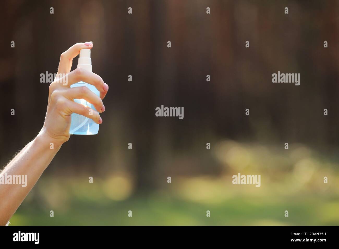 woman hand holding alcohol spray or anti bacteria spray outdoor to ...