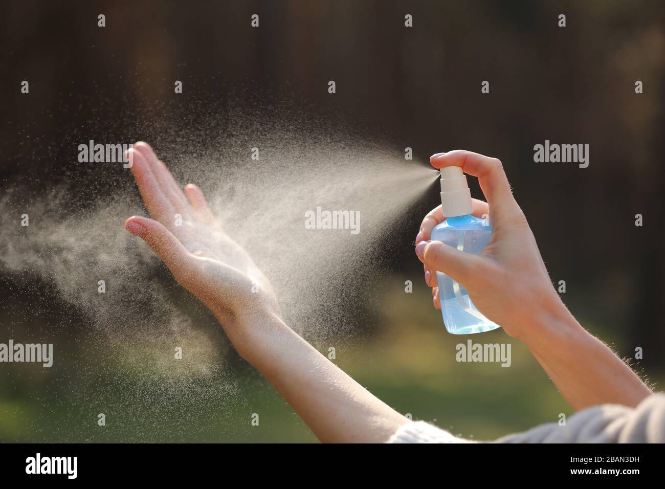 Close Up woman hands applying alcohol spray or anti bacteria spray ...