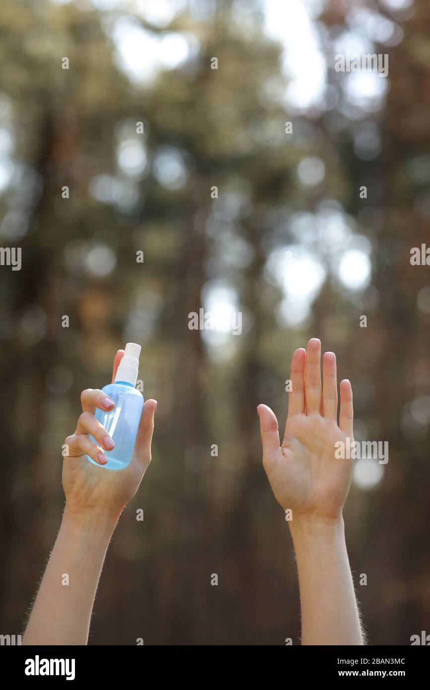 woman hands holding alcohol spray or anti bacteria spray outdoor to ...