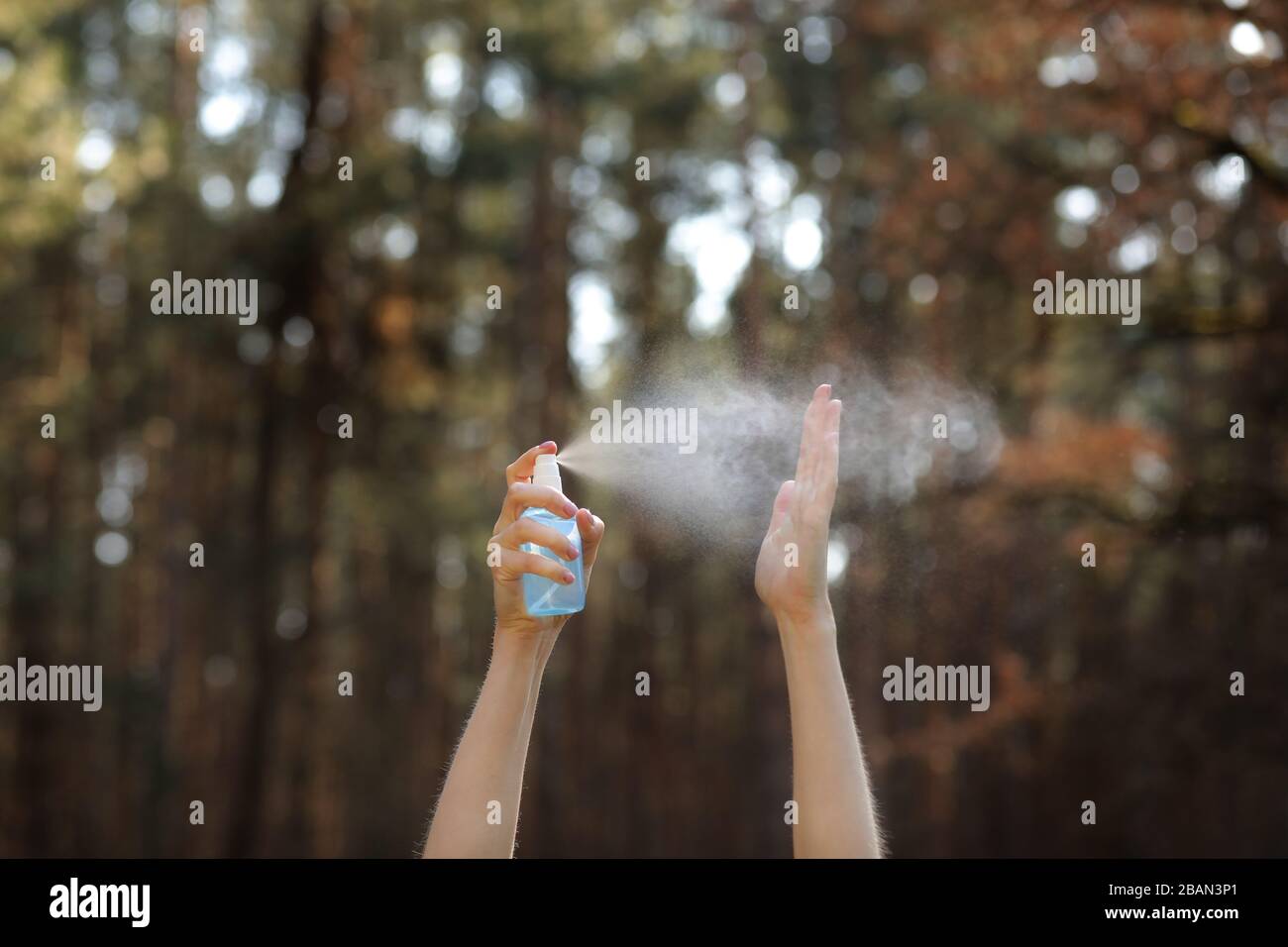 woman hands applying alcohol spray or anti bacteria spray outdoor to ...