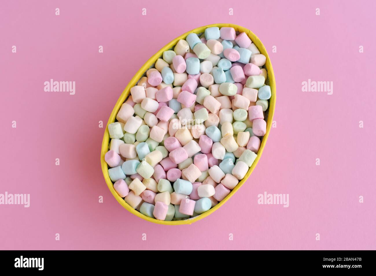 colored mini marshmallows in the shape of an easter egg on a pink ...