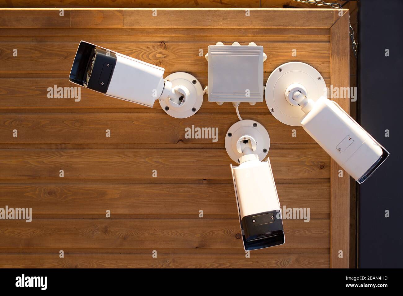 Three surveillance cameras under the wooden ceiling Stock Photo - Alamy