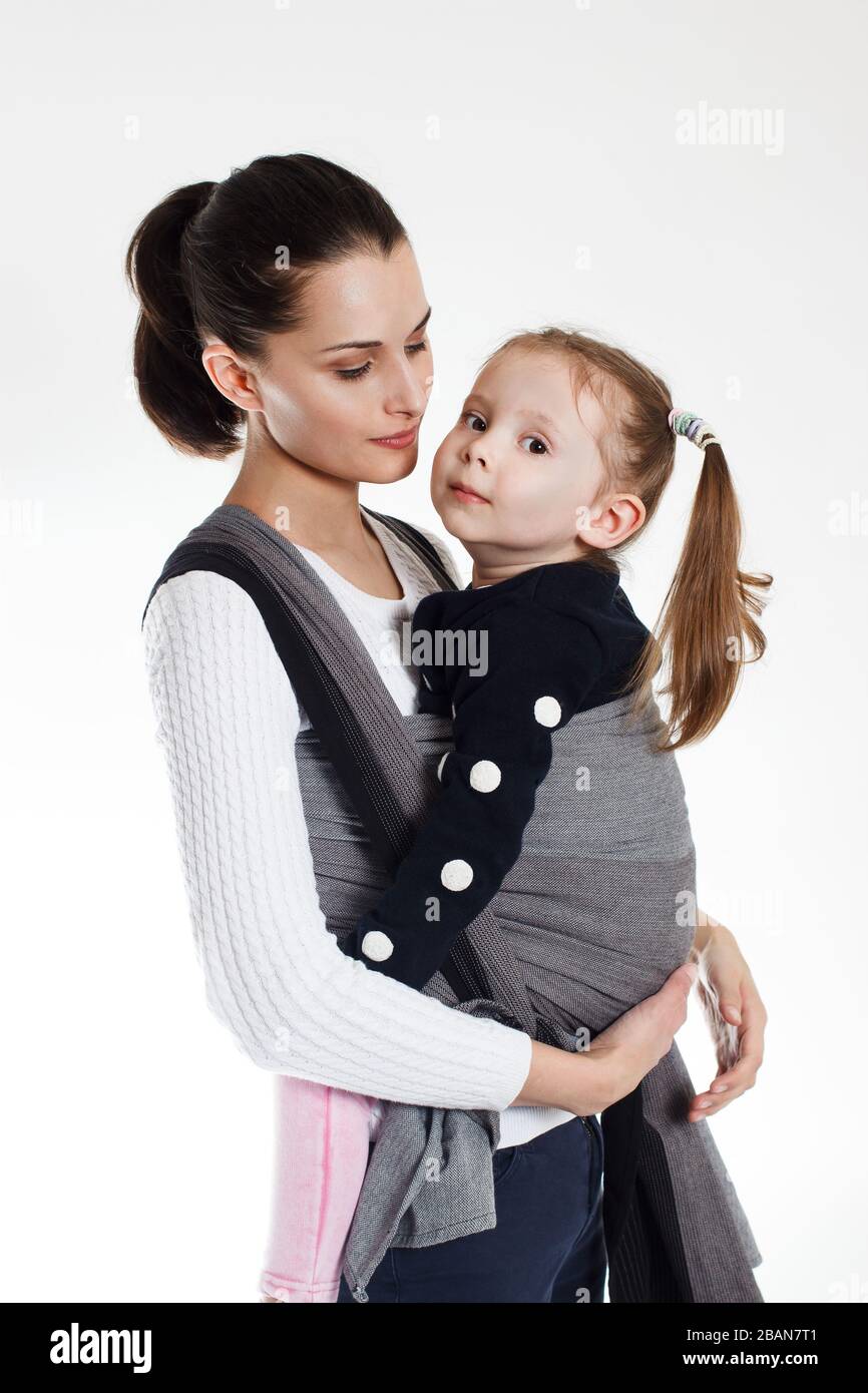 A toddler girl in front cross carry wrap in woven baby carrier Stock ...