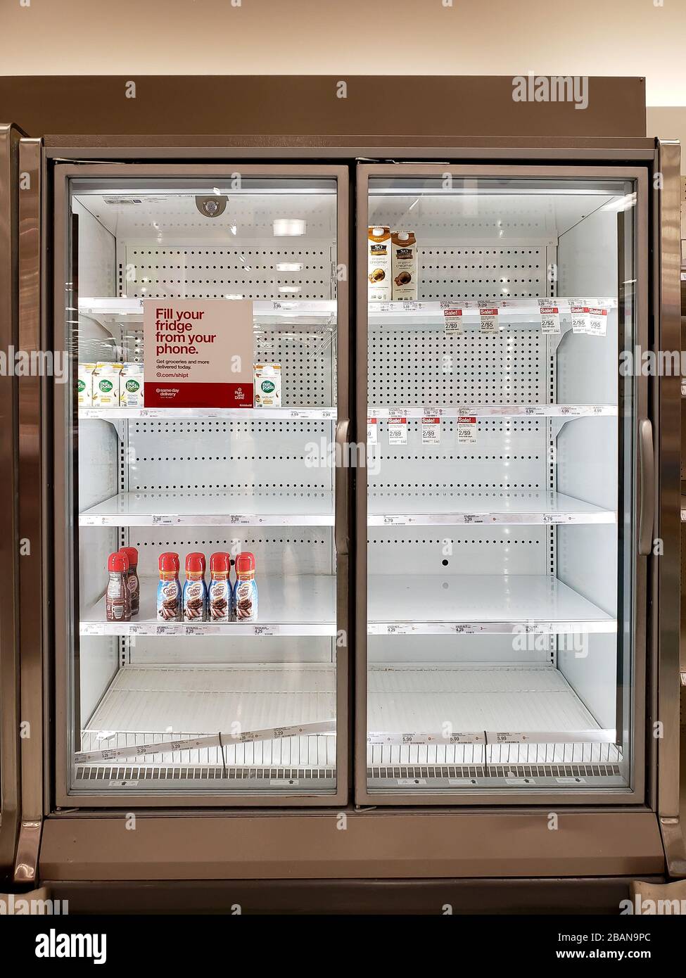 Nearly empty dairy refrigerator case at California market during the ...
