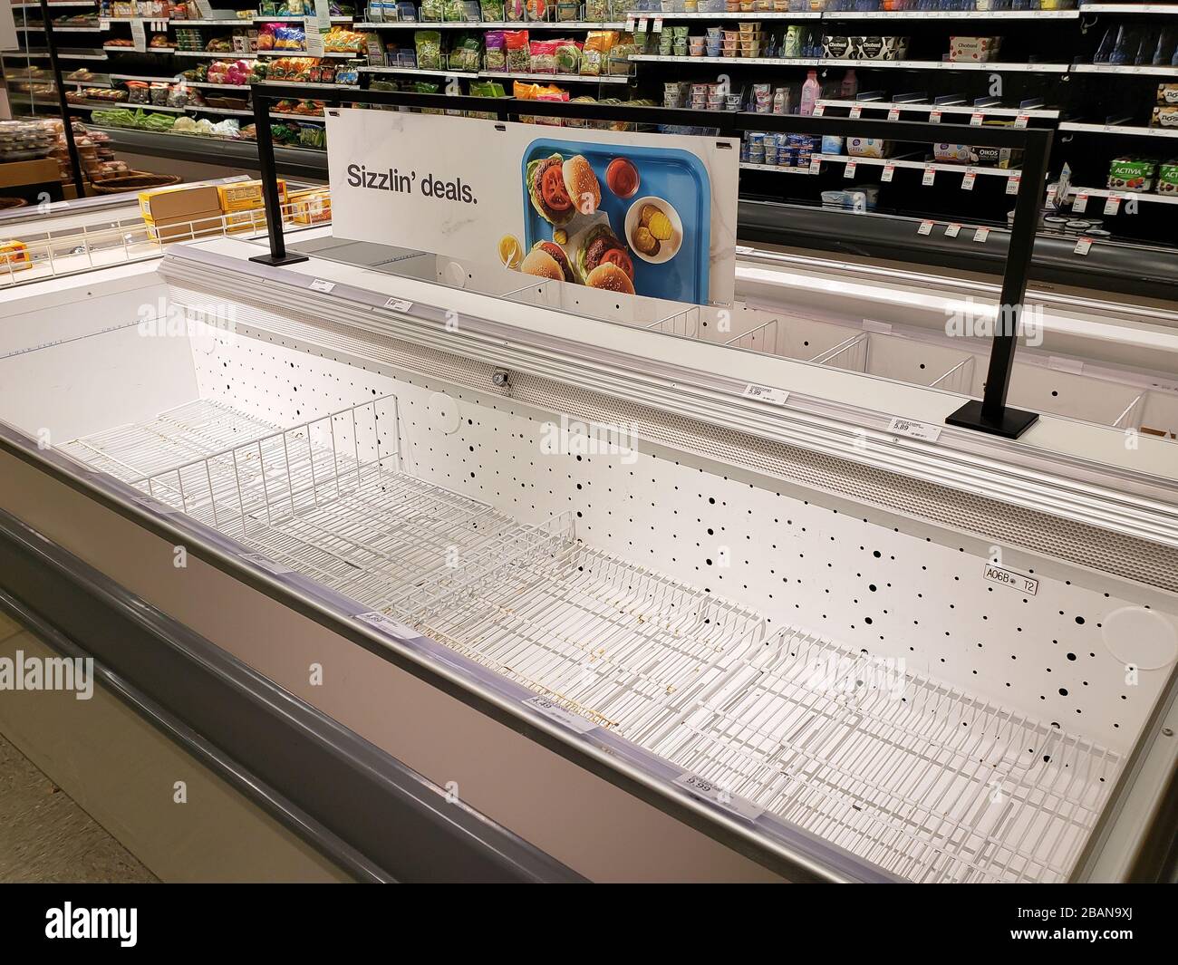 An empty meat refrigerator case at a California grocery store early in ...
