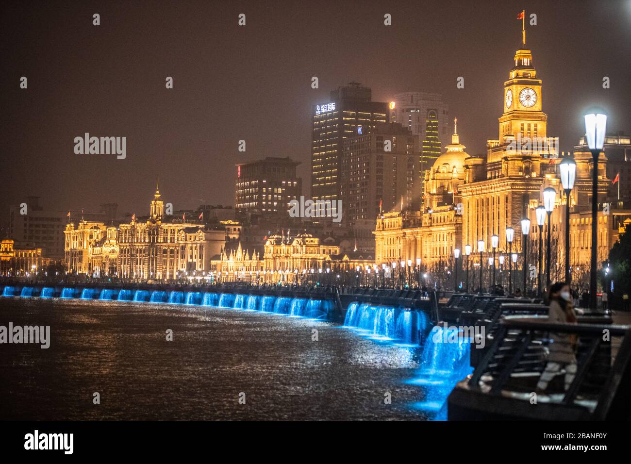 Color changing lights on the water backed by the bright glow of the ...