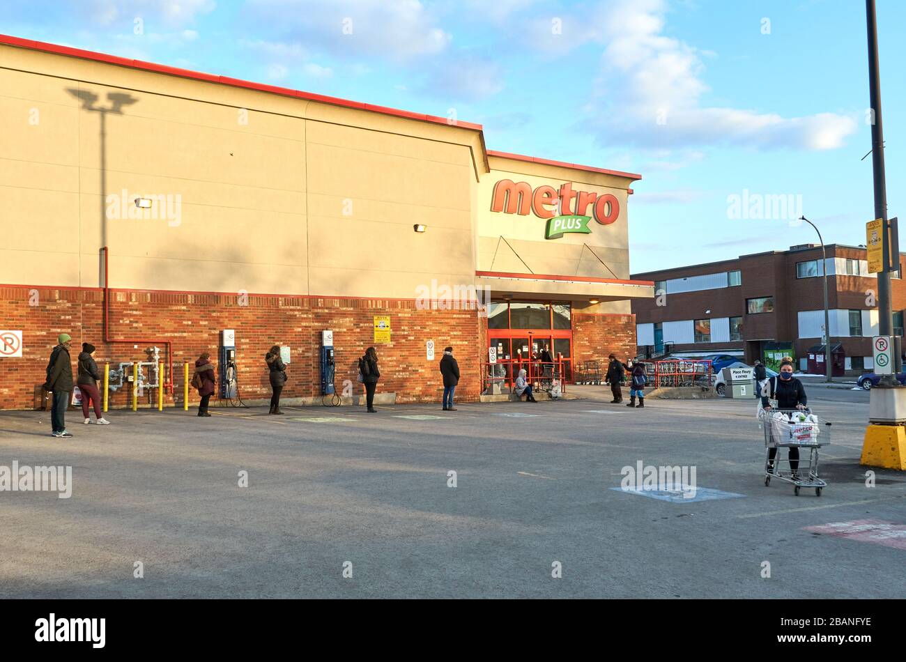Montreal, Canada - March 24, 2020: People in a line keeping social ...