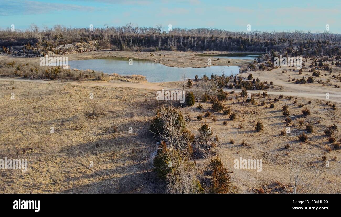 Abandoned Rock Quarry at Sunset. View from high above a barren plane ...