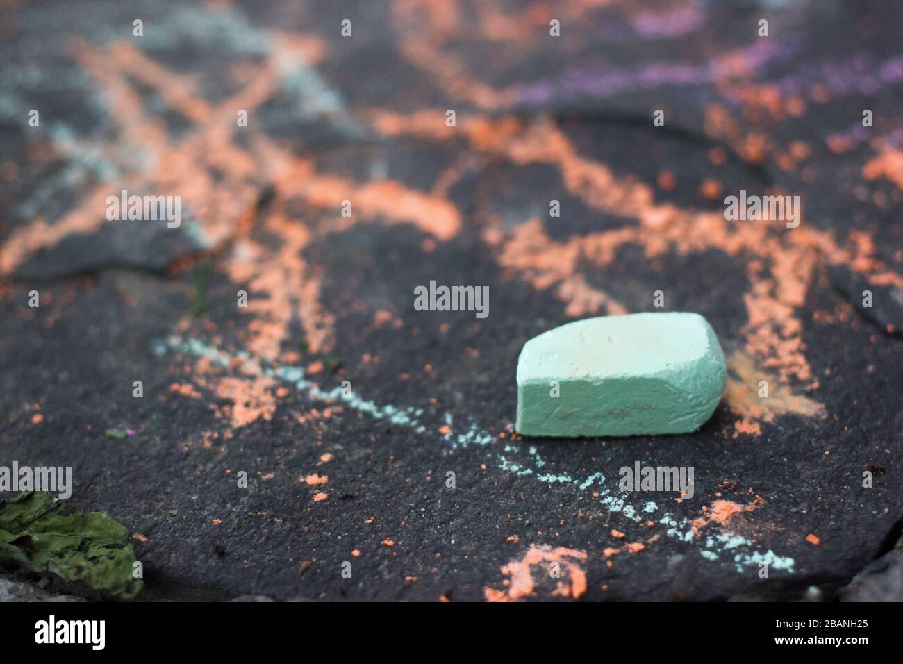 Close up view on small piece of used green chalk Stock Photo - Alamy