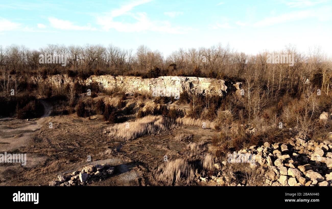 Abandoned Rock Quarry at Sunset. View from high above a barren plane ...