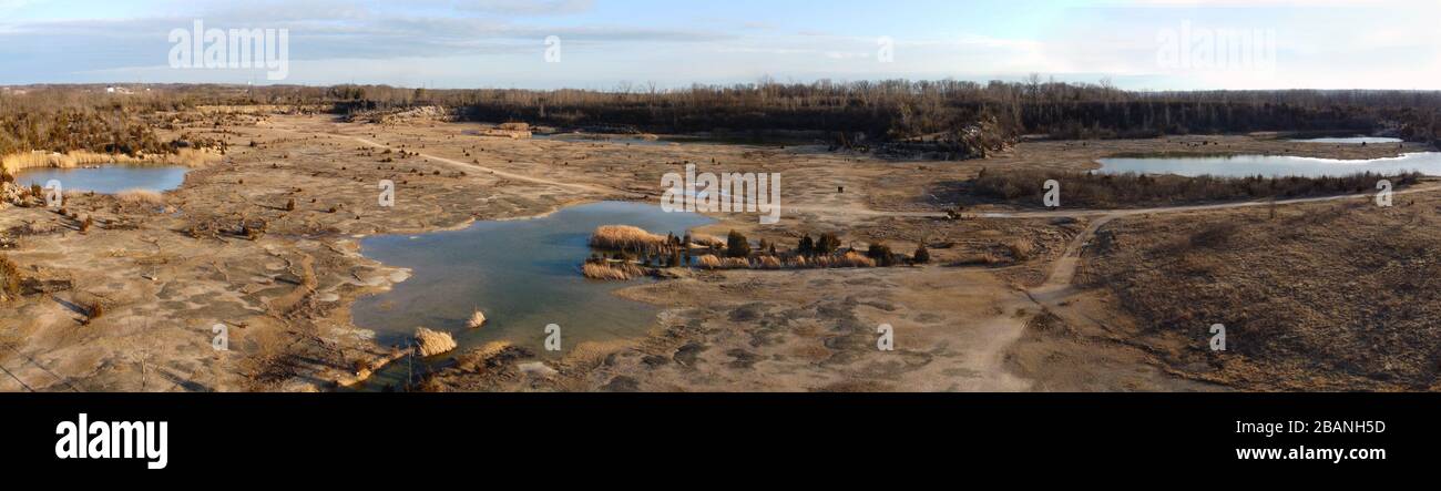 Abandoned Rock Quarry at Sunset. View from high above a barren plane ...