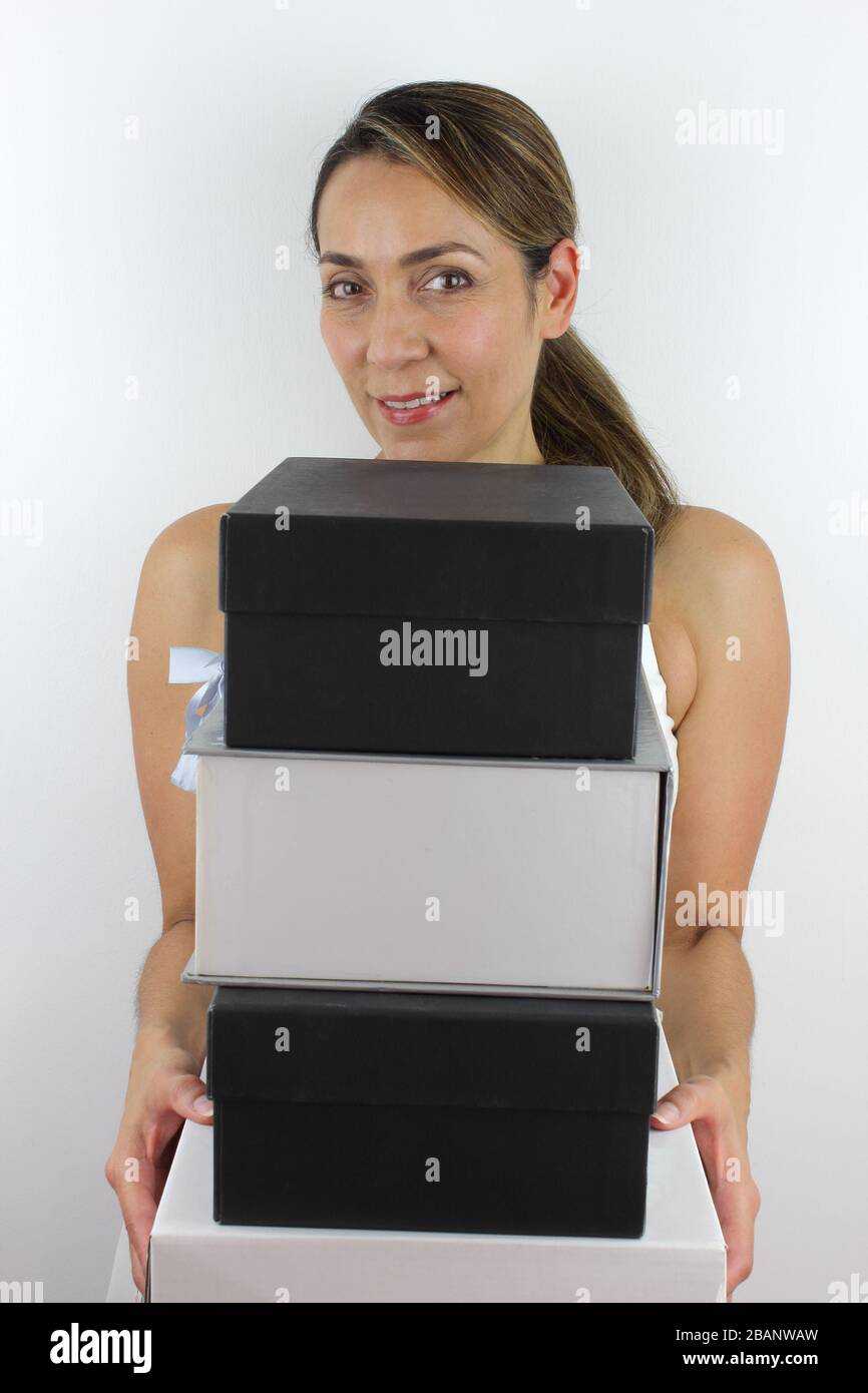 Beautiful woman with a handful of shopping boxes Stock Photo - Alamy