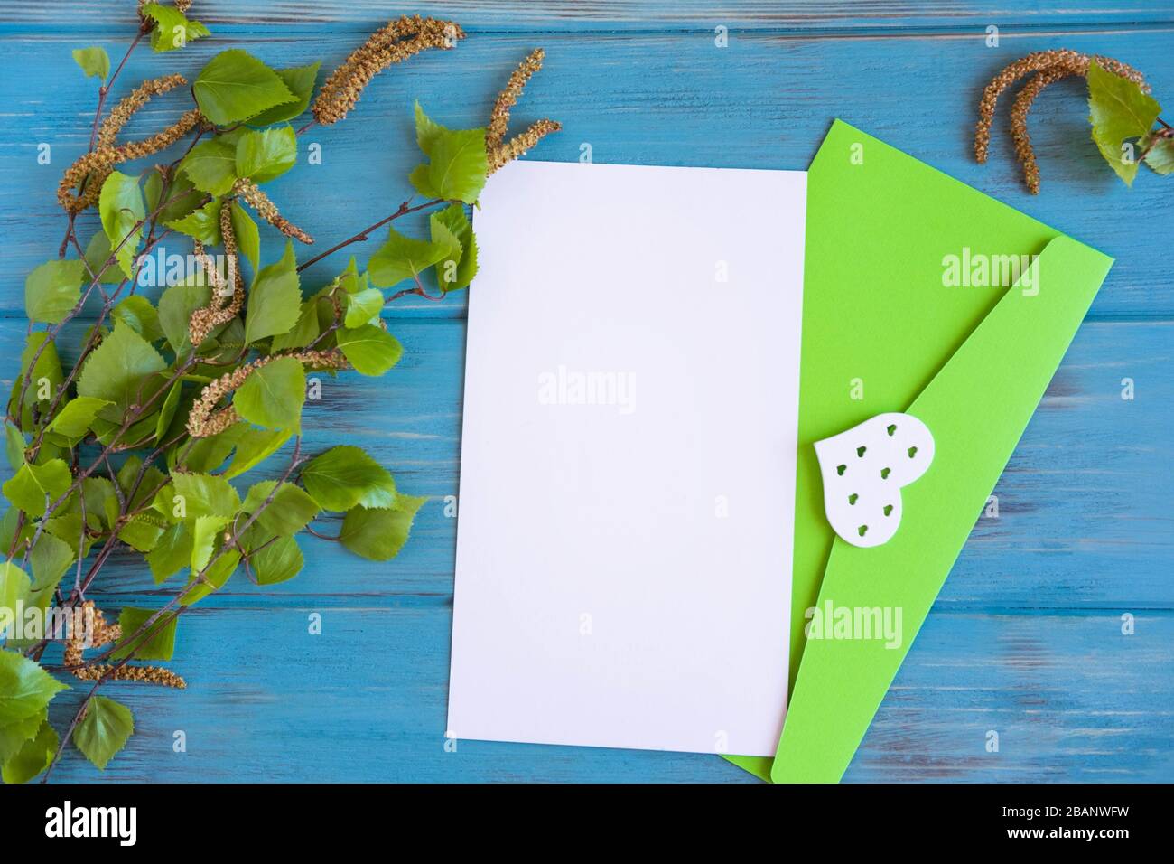 Mock up blank of a spring blank with birch branches on an aged blue ...