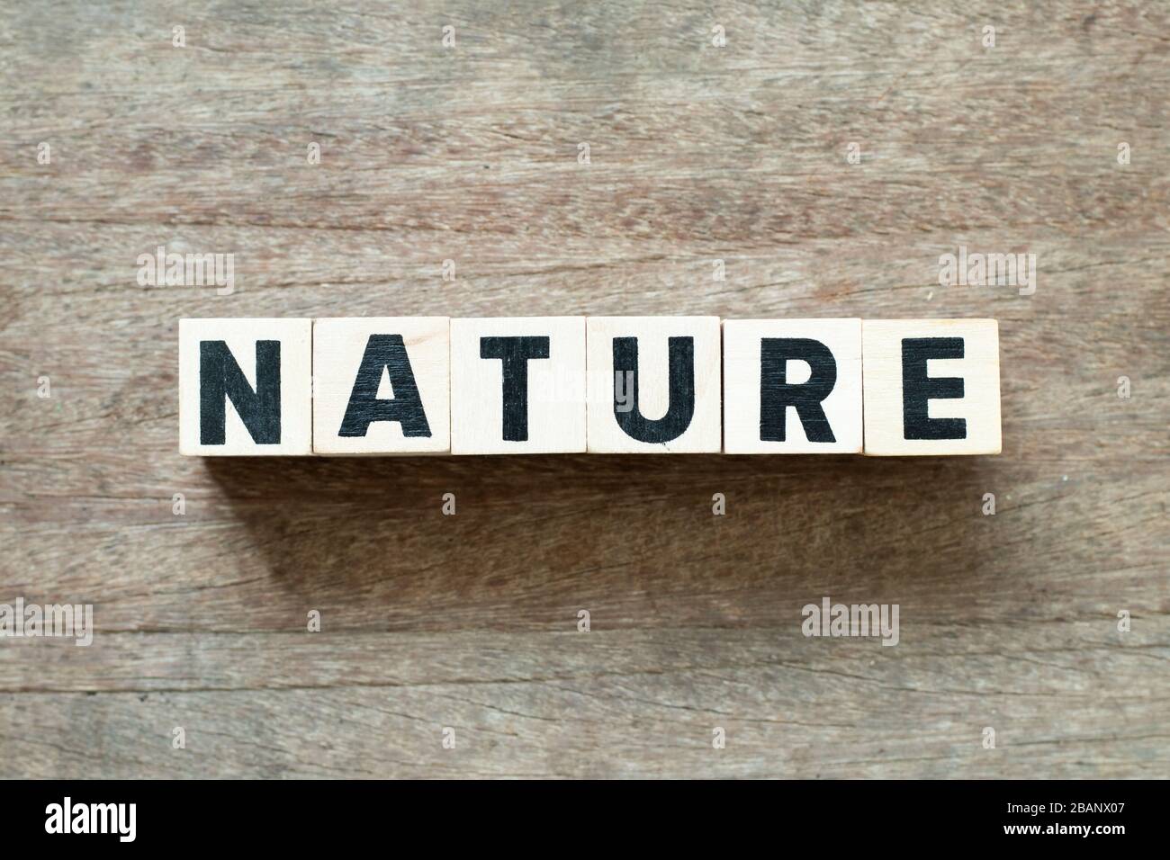 Letter block in word nature on wood background Stock Photo - Alamy