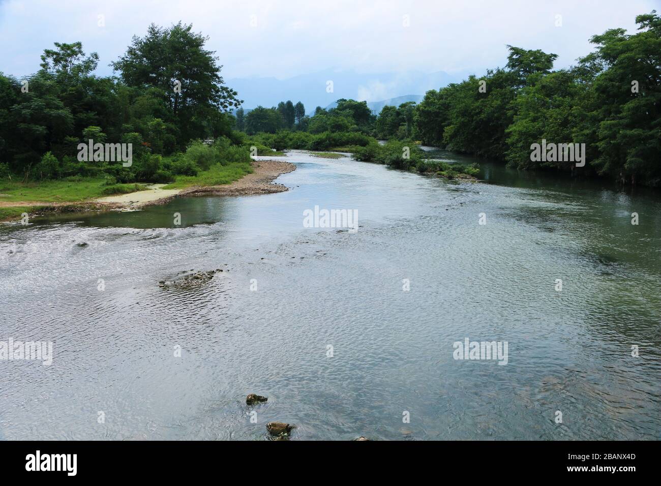 A small river running through a valley Stock Photo - Alamy