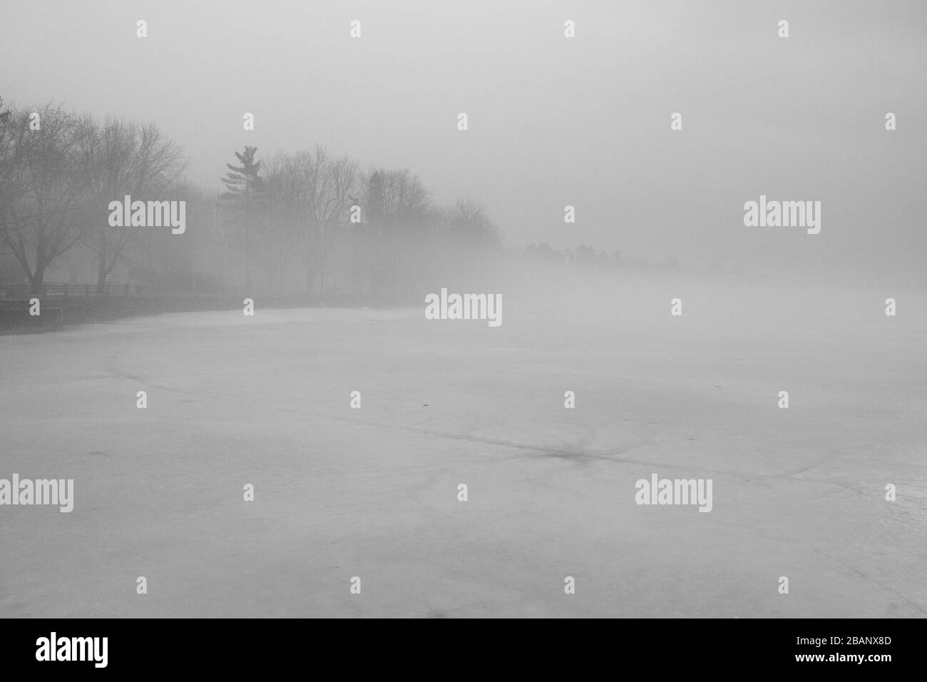 Spring warm temperatures create a thick fog on a still frozen (but ...