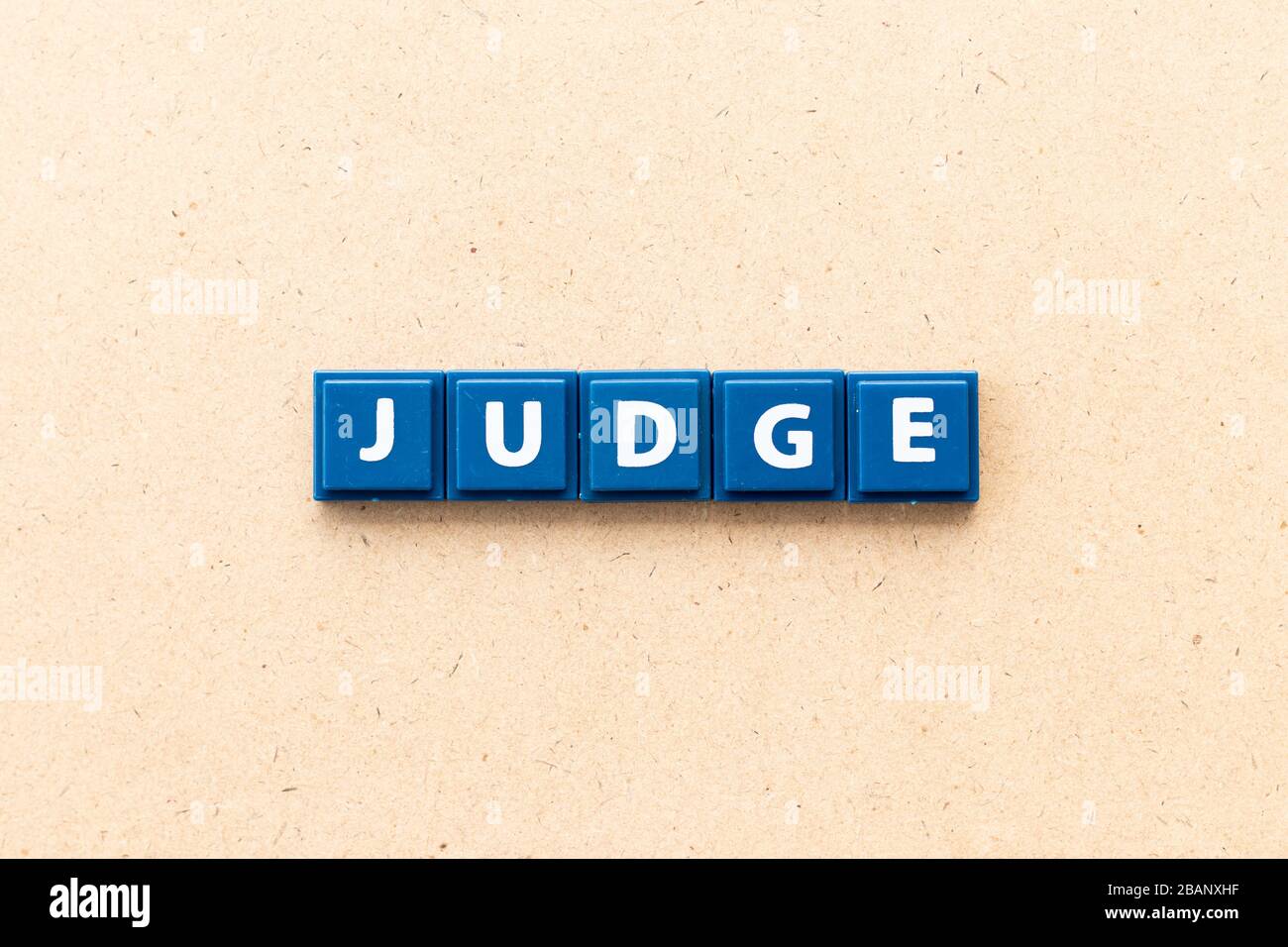 Tile letter in word judge on wood background Stock Photo - Alamy