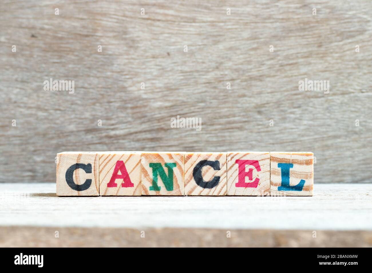 Letter block in word cancel on wood background Stock Photo - Alamy