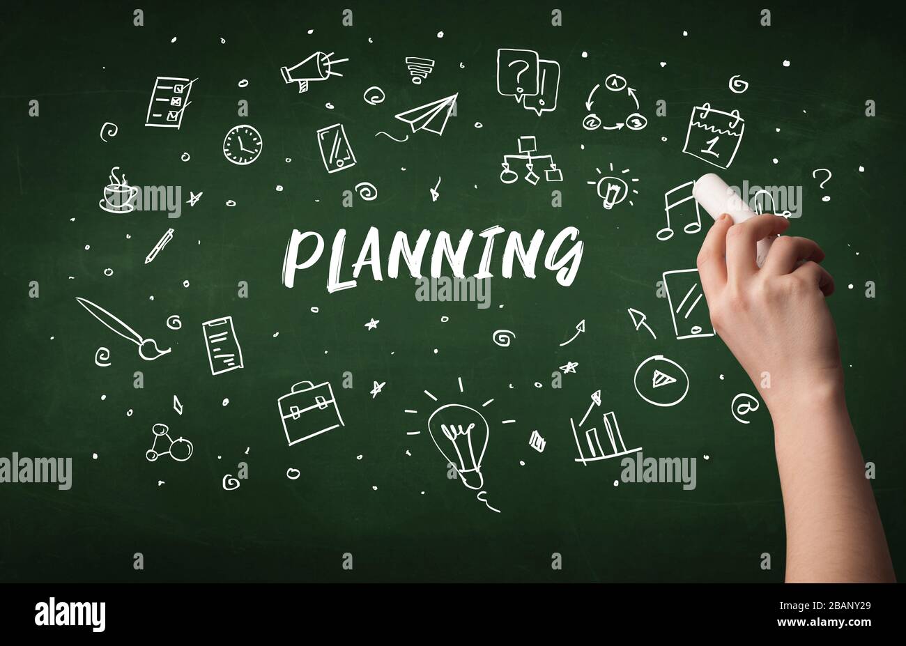 Hand drawing PLANNING inscription with white chalk on blackboard ...