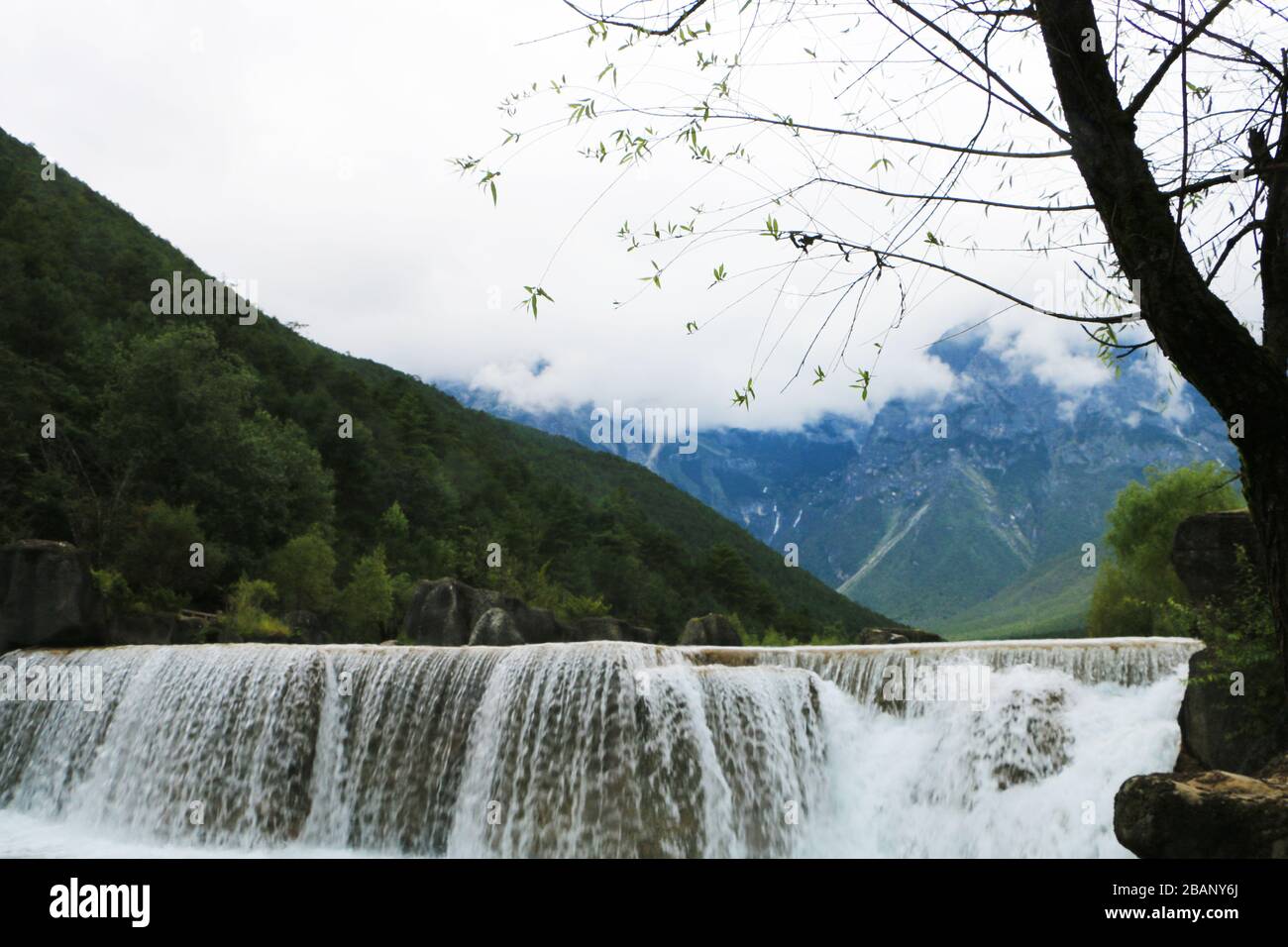 A waterfall in a valley Stock Photo - Alamy