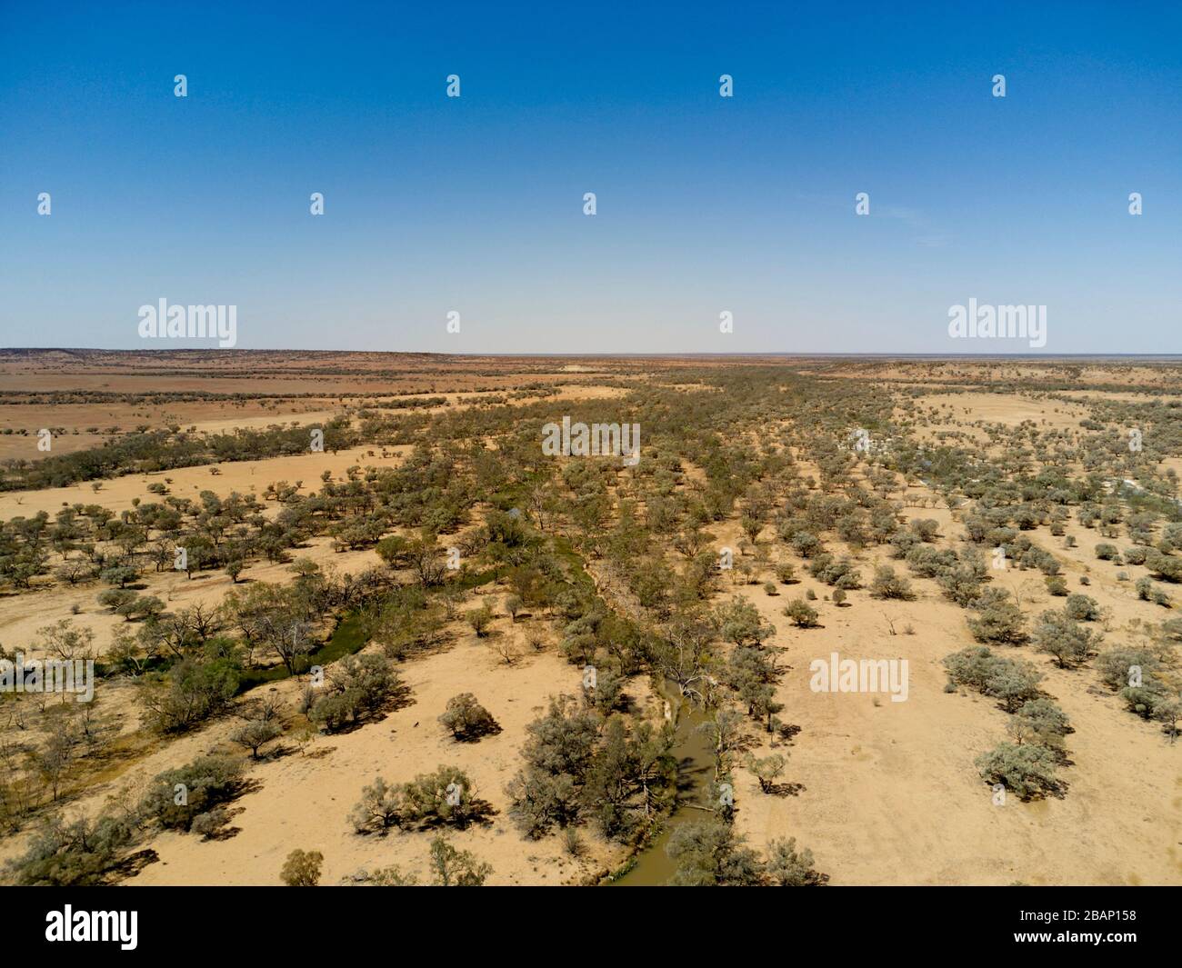 Aerial of Jackson Creek as it flows across the arid desert landscape ...