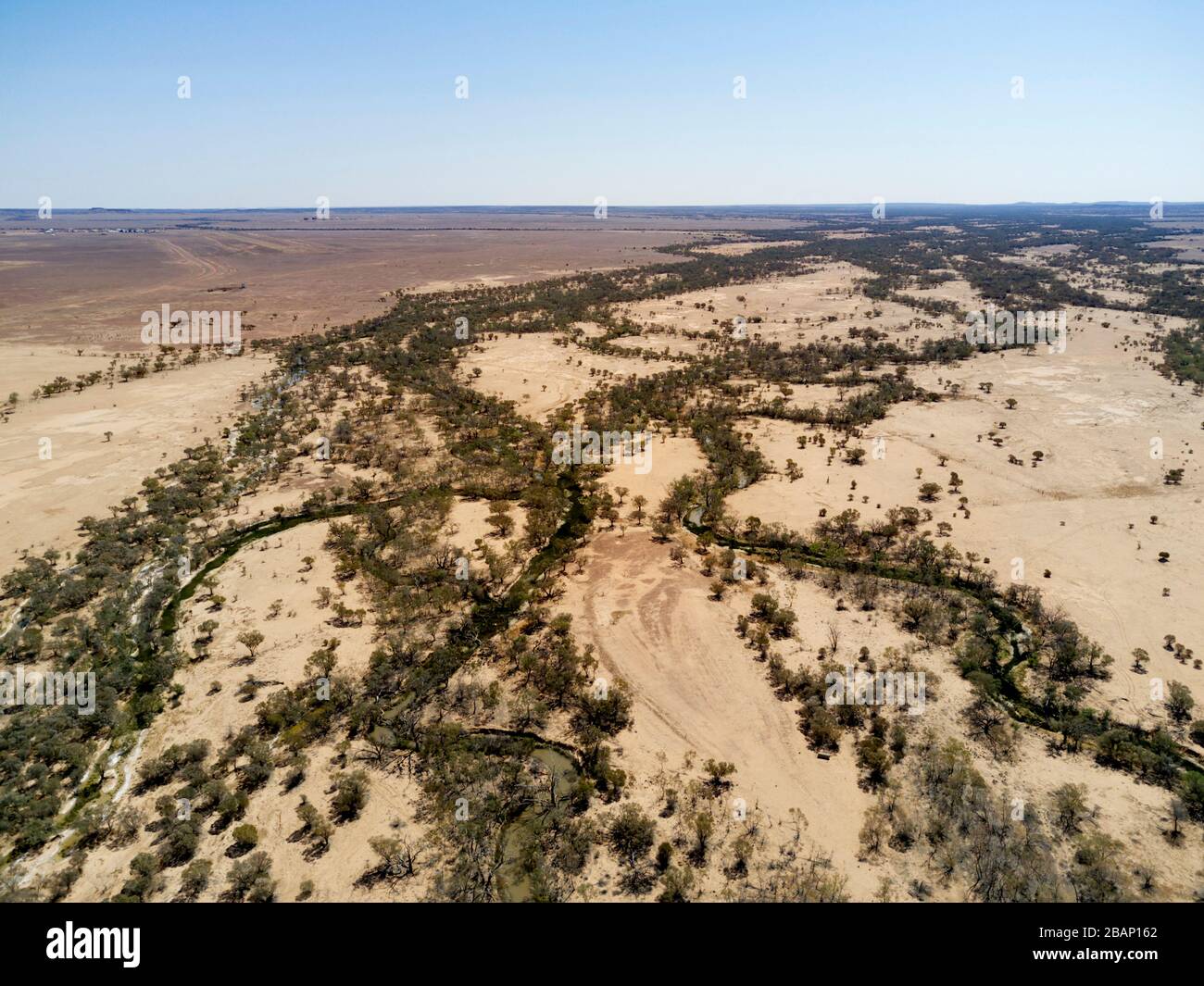 Aerial of Jackson Creek as it flows across the arid desert landscape ...