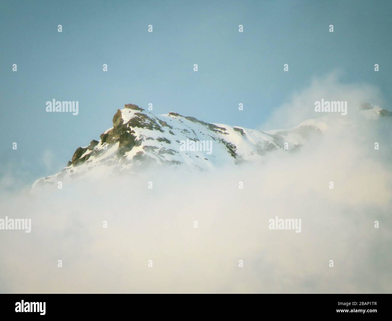 View of ice capped mountain surrounded by fog Stock Photo - Alamy