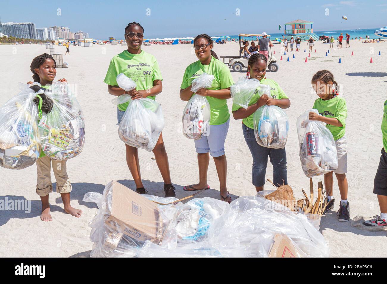 Teamwork working together helping cleaning up collecting trash litter ...