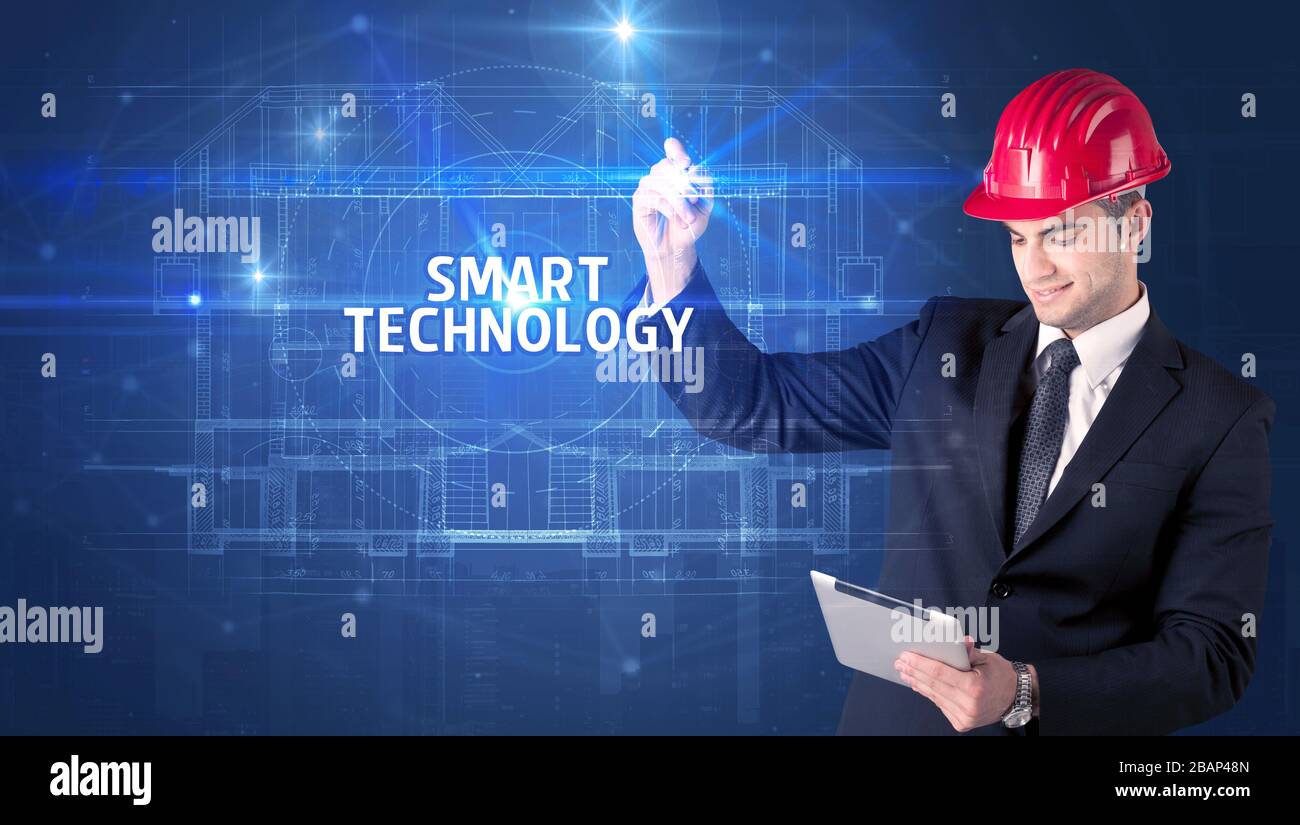 Handsome architect with helmet drawing SMART TECHNOLOGY inscription ...