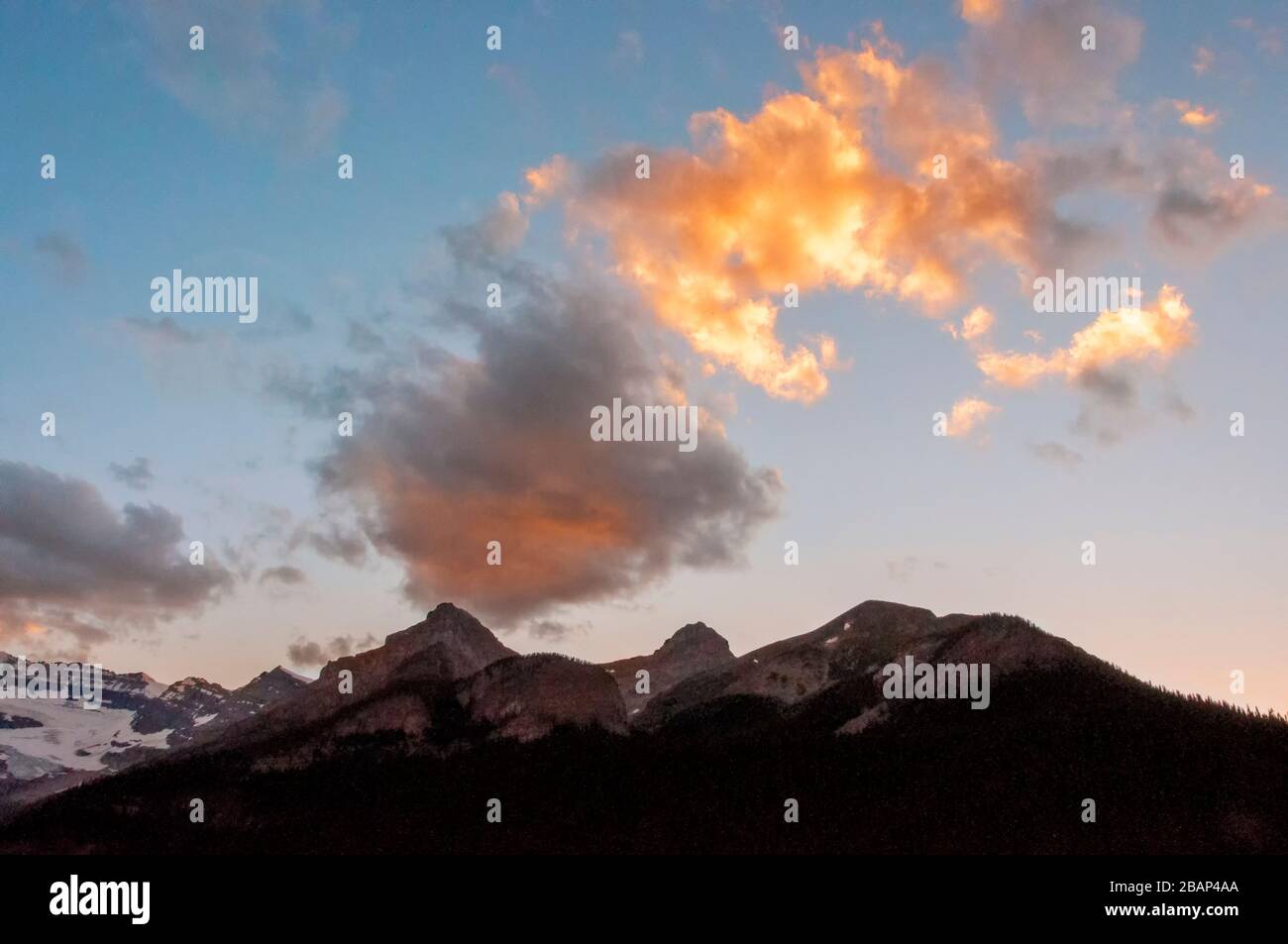 Sunset over rocky mountains at Lake Louise, Banff, Canada Stock Photo ...