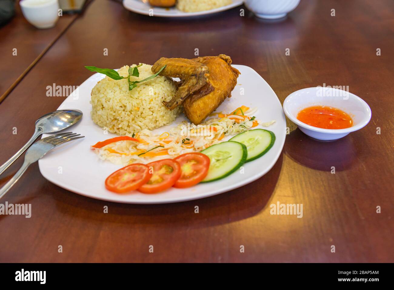 Plate of tasty deep-fried chicken wing and rice in restaurant Stock ...