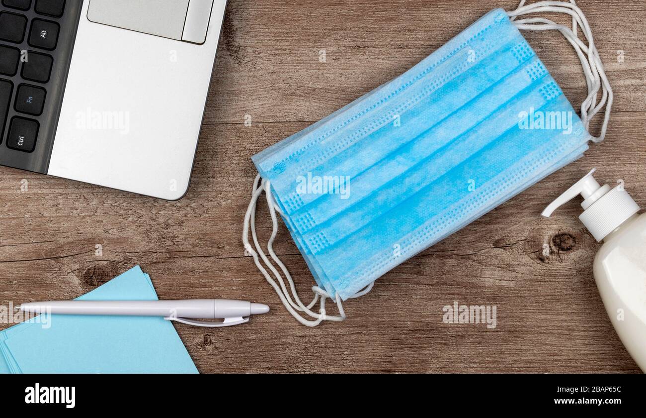 hygiene in the office. remote work kit on wooden desk. sanitizer gel ...