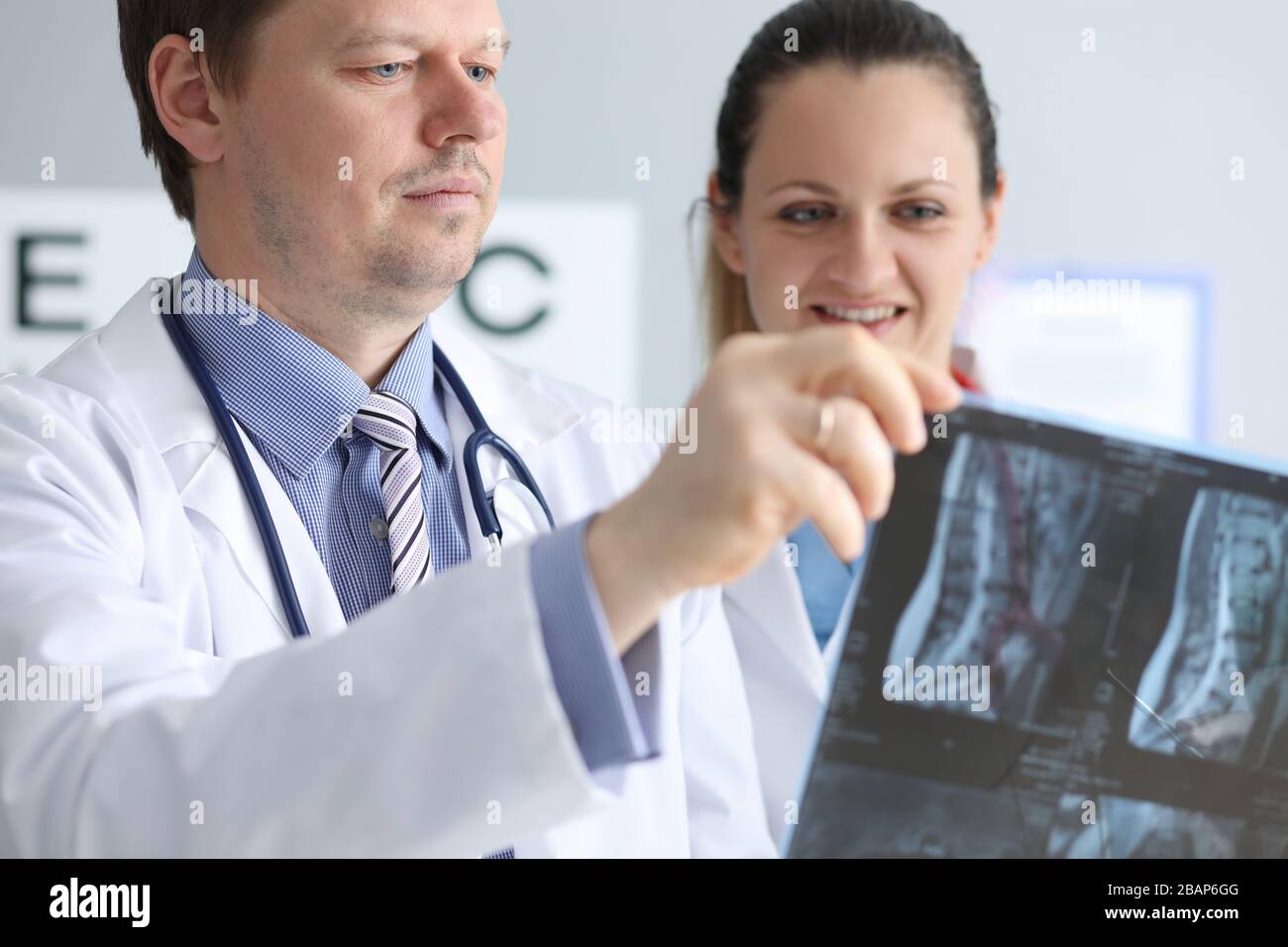 Male and female doctors carefully look at an x-ray Stock Photo - Alamy