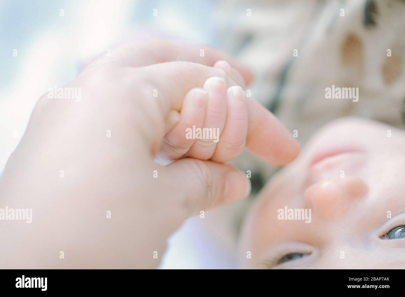 Baby holding hands hi-res stock photography and images - Alamy