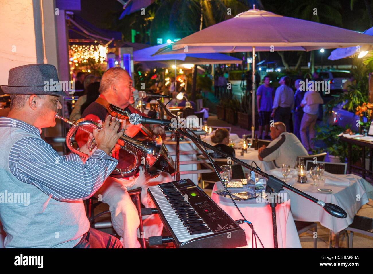 Night nightlife evening al fresco sidewalk outside outdoors tables hi ...