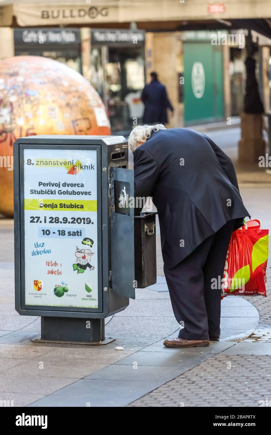 Man digging in garbage can hi-res stock photography and images - Alamy