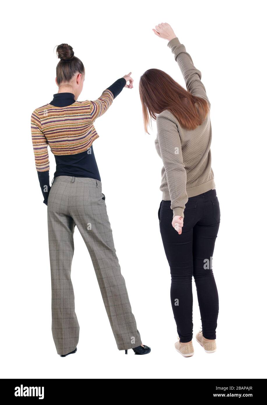 Back view of two pointing girl in sweater. Rear view people collection ...