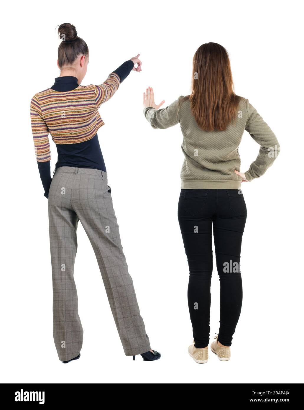 Back view of two pointing girl in sweater. Rear view people collection ...