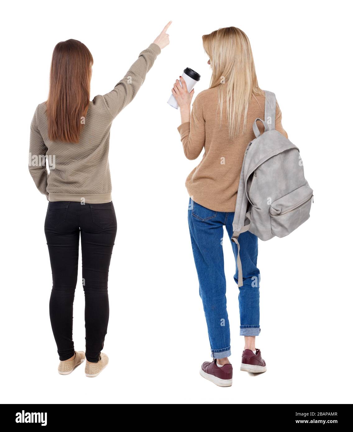 Back view of two pointing girl in sweater. Rear view people collection ...