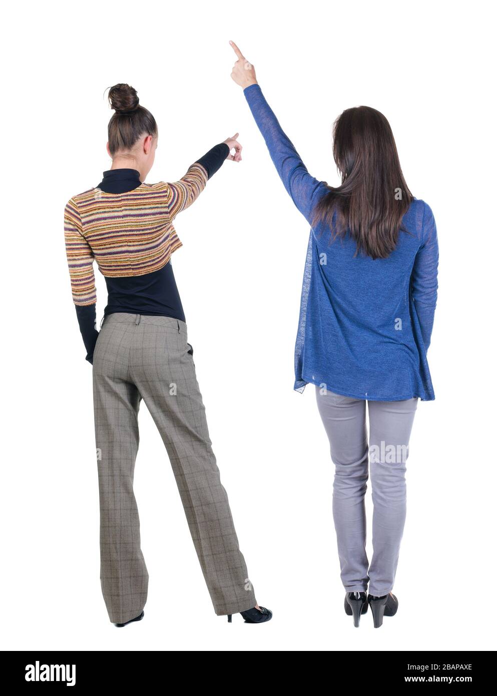 Back view of two pointing girl in sweater. Rear view people collection ...