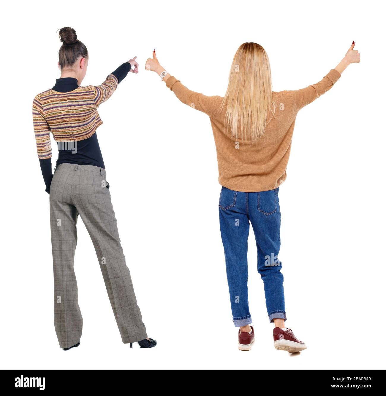 Back view of two pointing girl in sweater. Rear view people collection ...